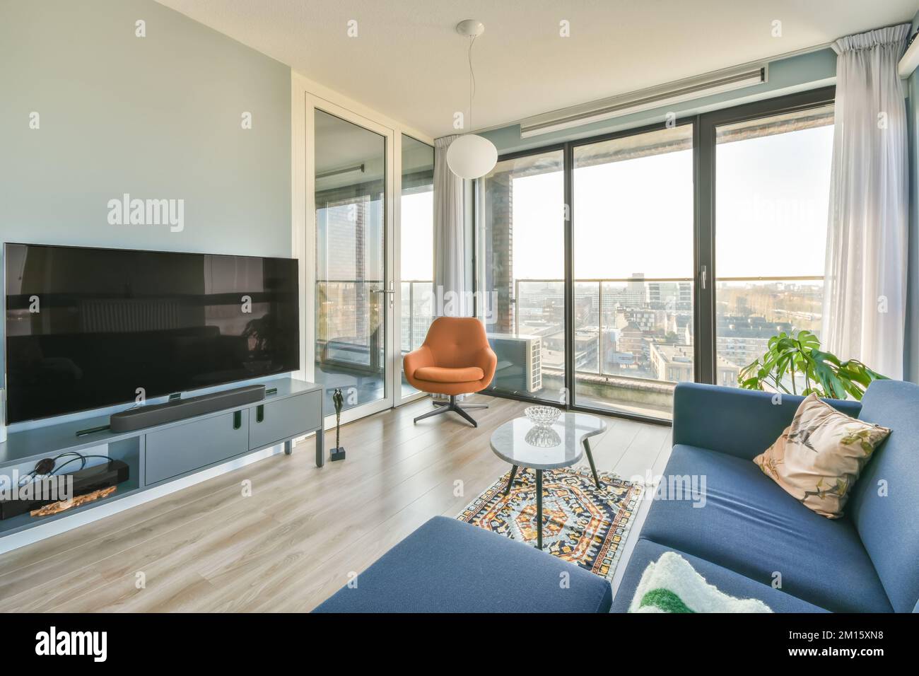 Interior of modern spacious apartment furnished with couch and table ...
