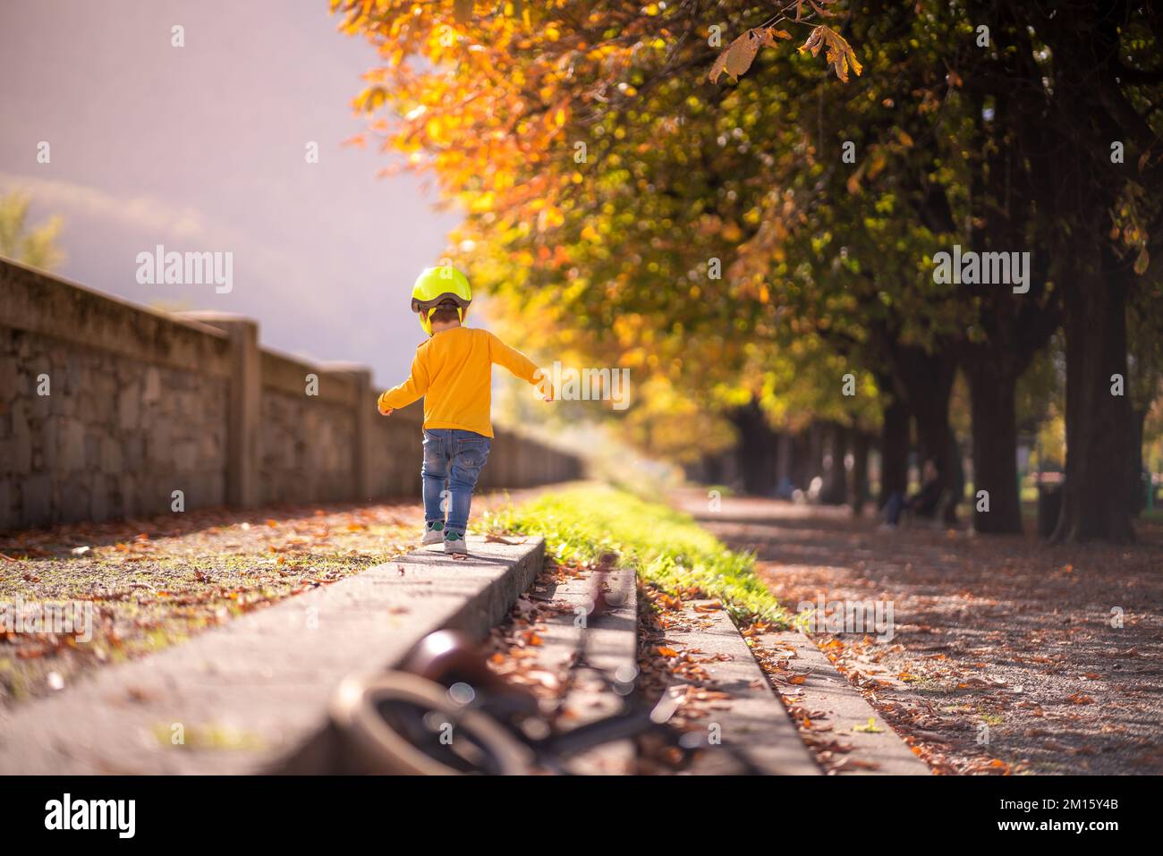 Back view full body of little kid in casual outfit walking on stairway ...