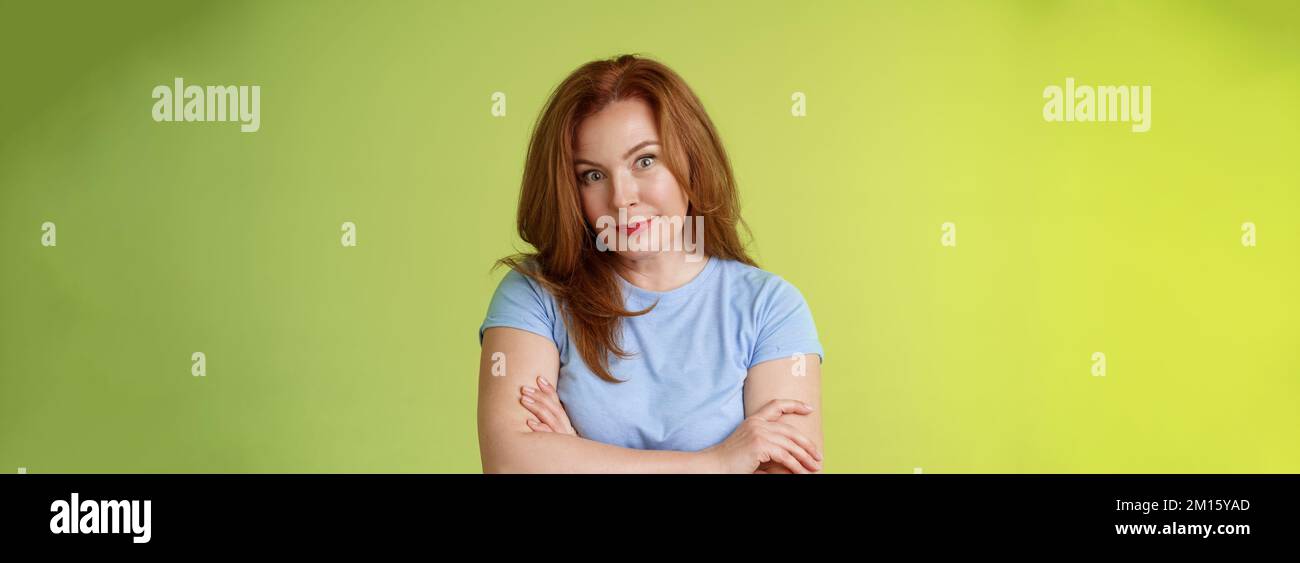 Confused shocked redhead mother look serious worried puzzled cross arms ...