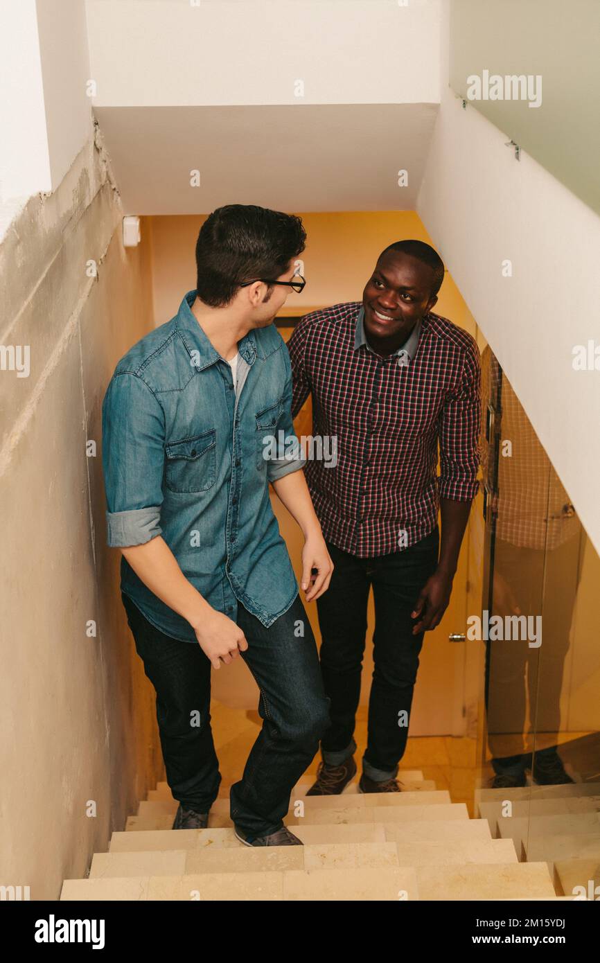 Two men climbing ladder hi-res stock photography and images - Alamy