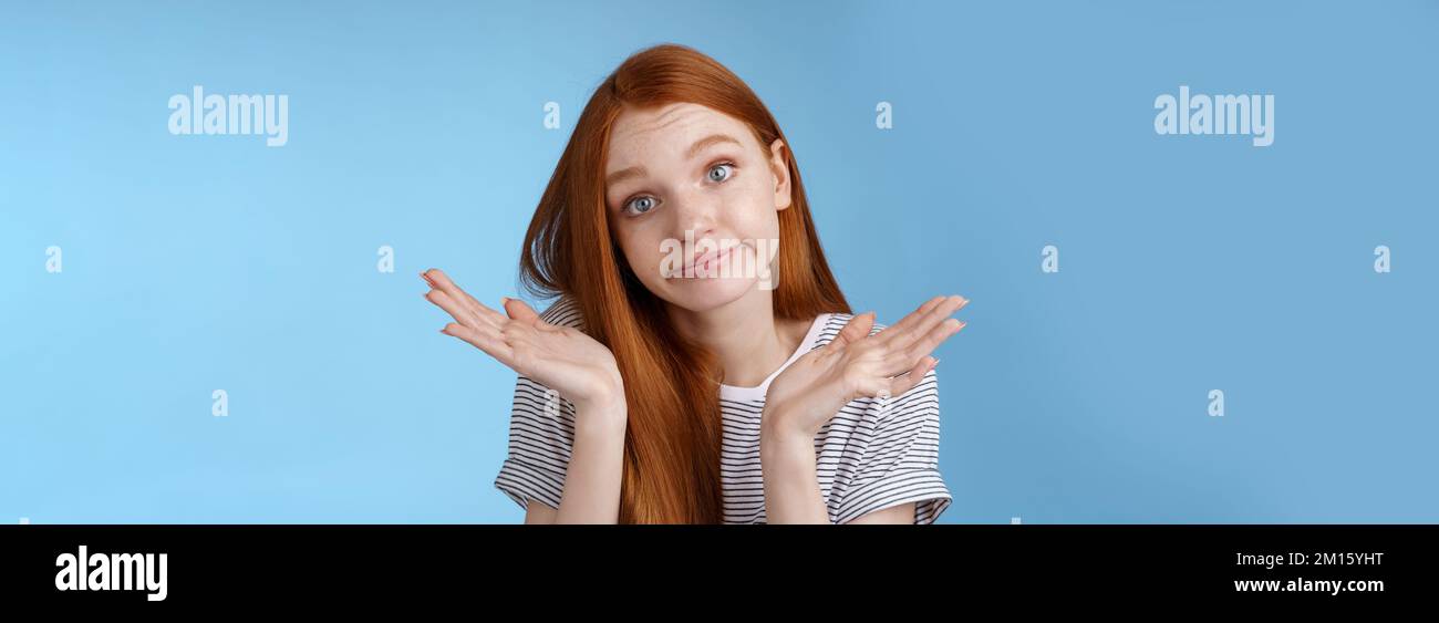Unsure clueless cute silly redhead female part-time worker shrugging ...