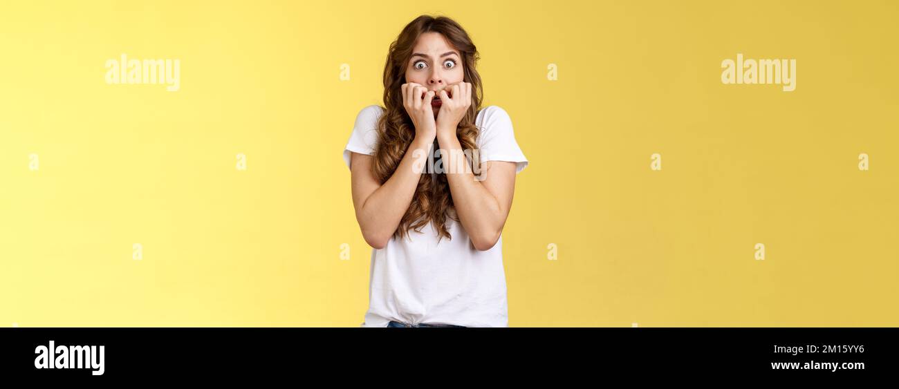Shocked speechless scared stunned curly-haired caucasian woman gasping ...
