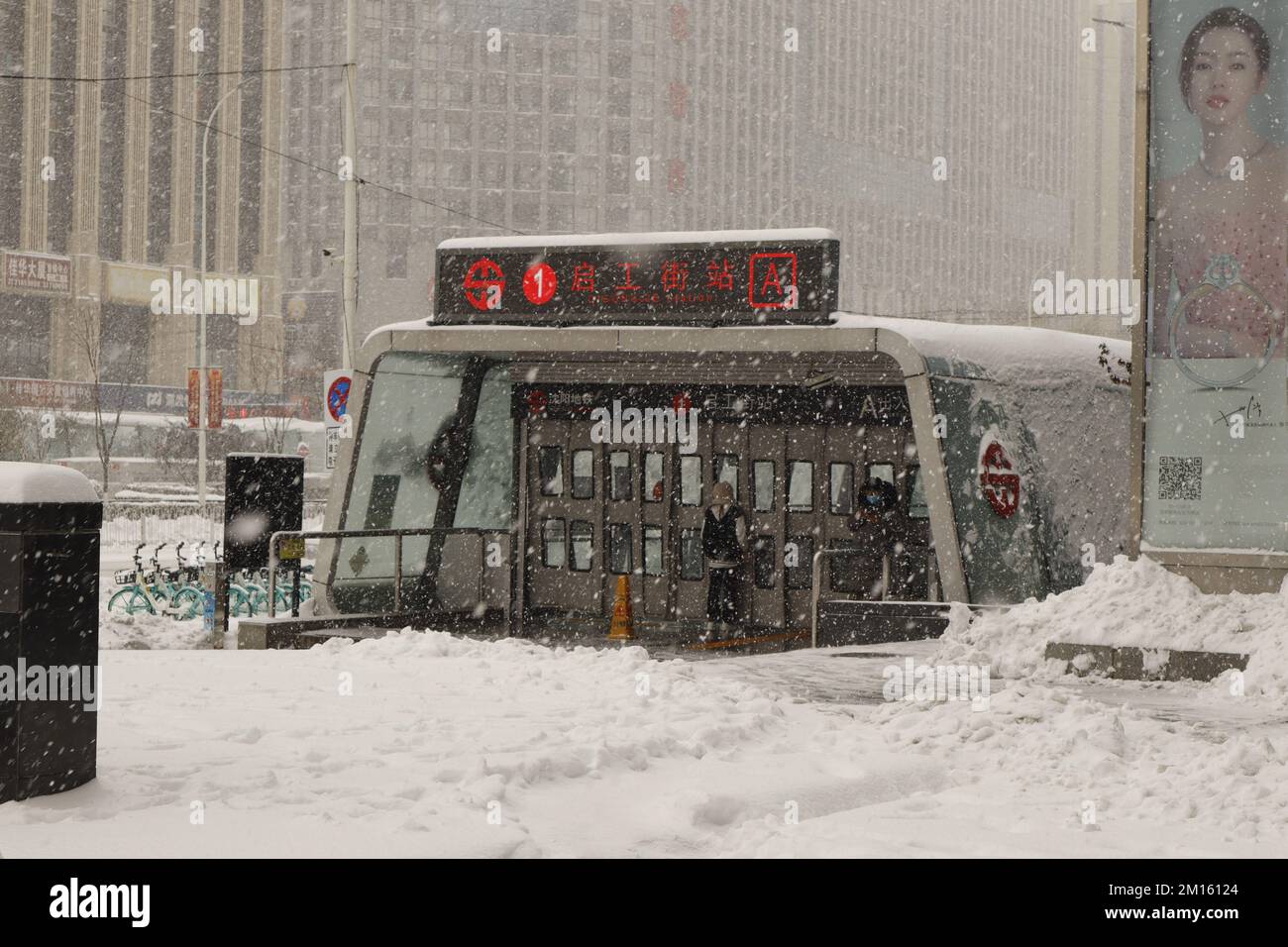 A public transportation stop under snowfall in the snowy streets of ...