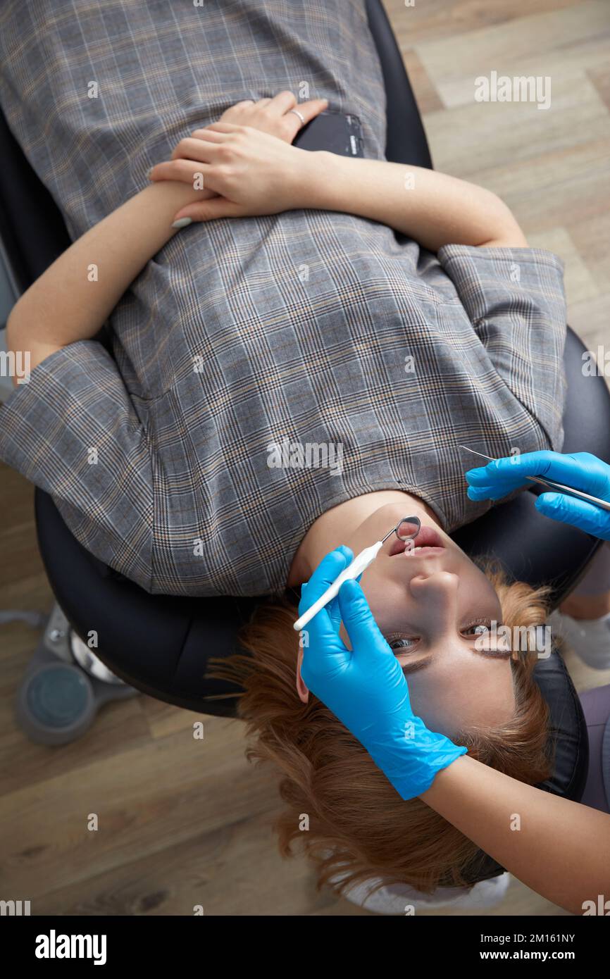 Dentist checking teeth of a female patient with dental mirror Stock ...