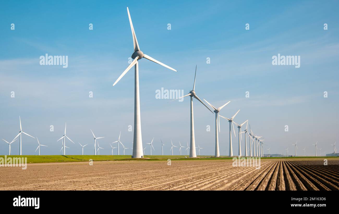 Windmill par with wind mill turbines generating electricity with a blue ...