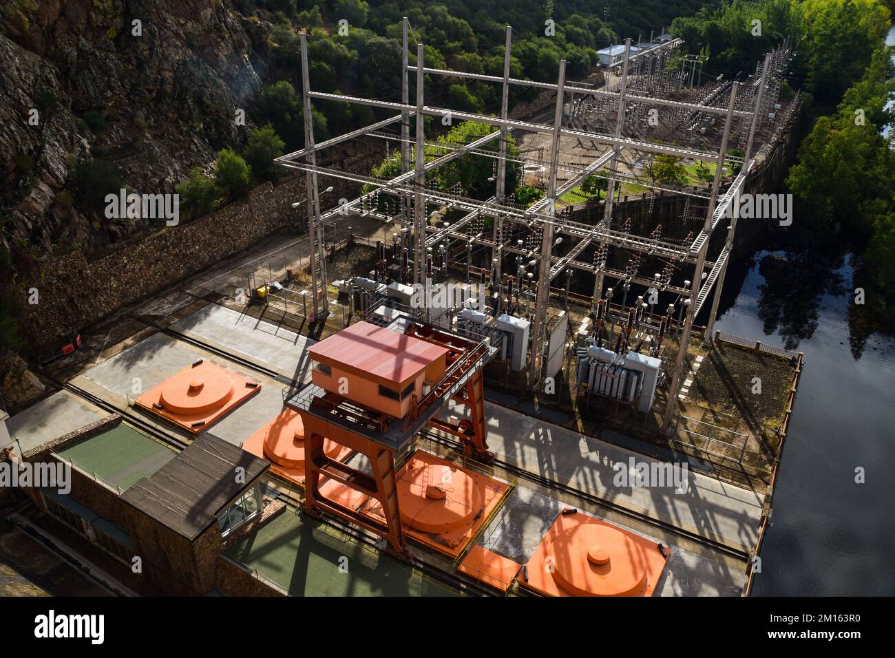 Electrical substation with bridge crane in waterfall Stock Photo - Alamy