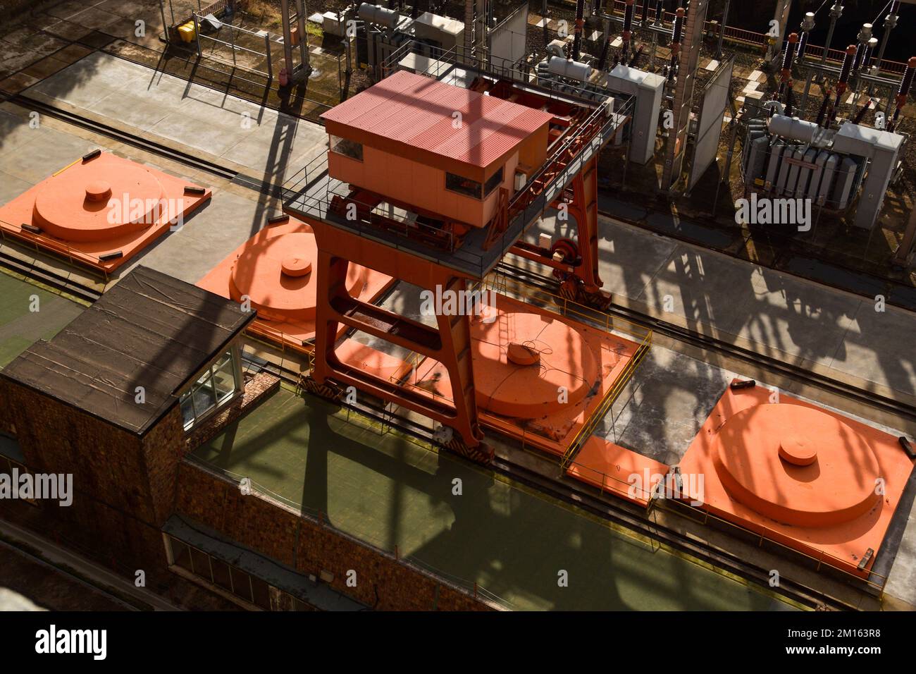 Electrical substation with bridge crane in waterfall Stock Photo - Alamy
