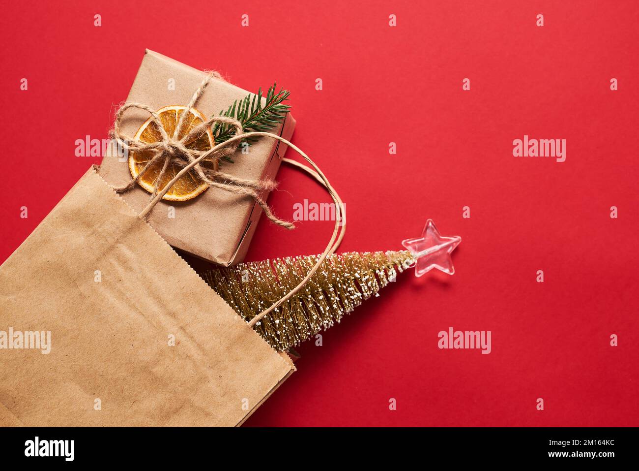 Small christmas gift wrapped in craft paper Stock Photo - Alamy