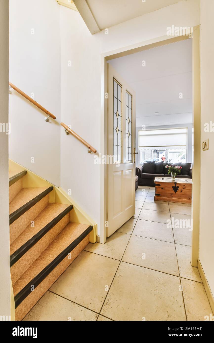the inside of a house with stairs leading up to the living room and ...