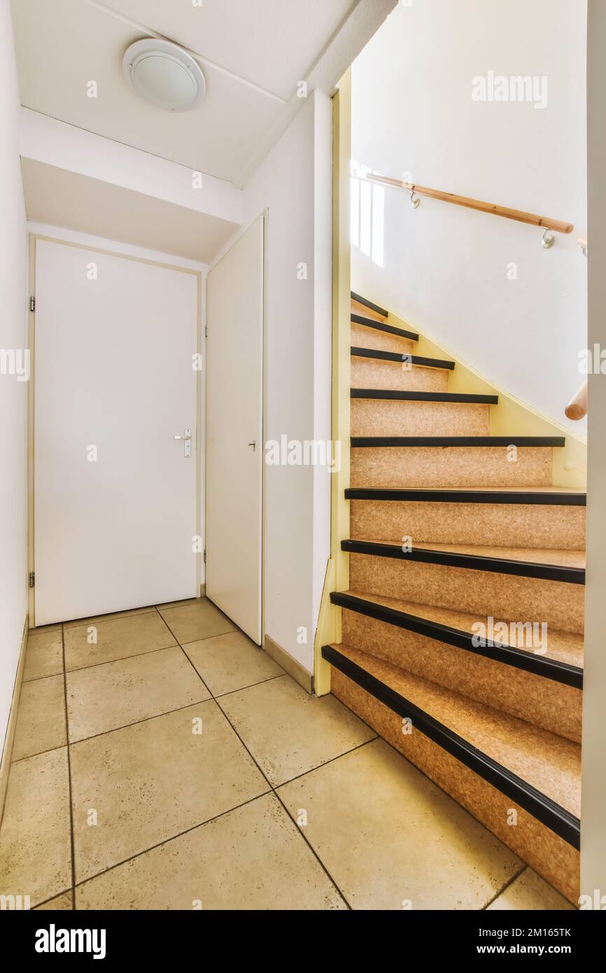 an empty room with stairs and a light fixture on the left hand side of ...