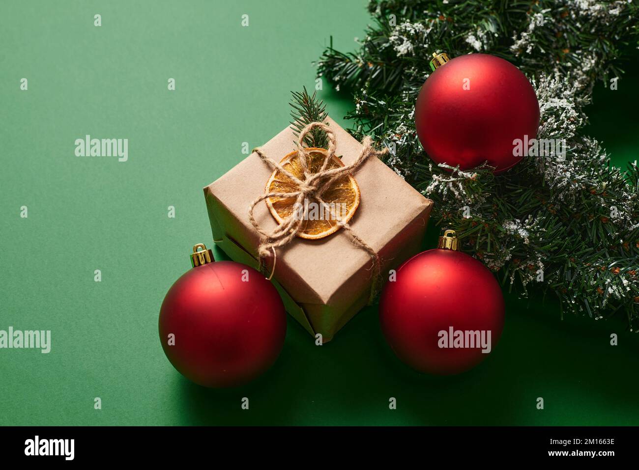 decorative Christmas trees and gift boxes on red background against red ...