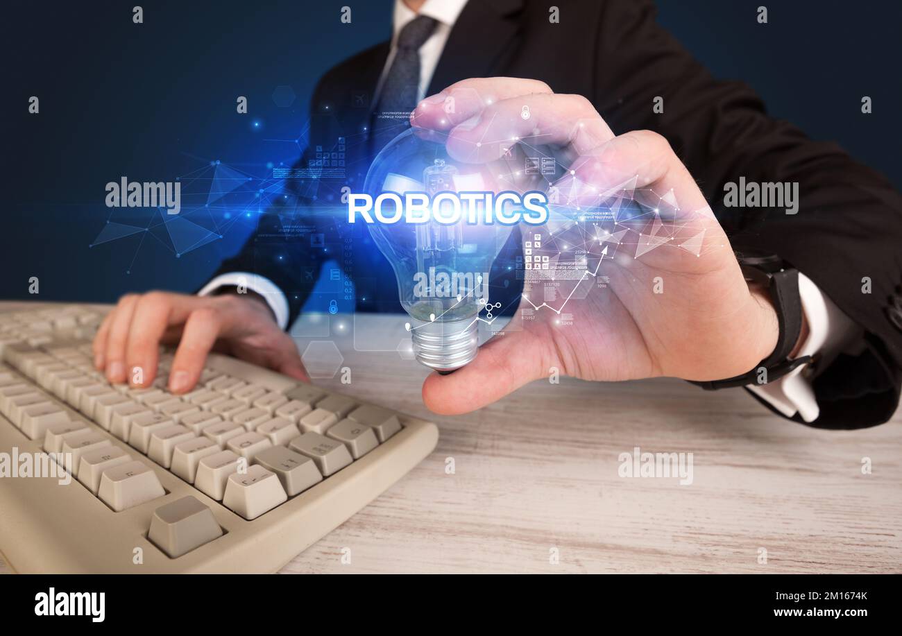 Businessman holding a light bulb Stock Photo - Alamy