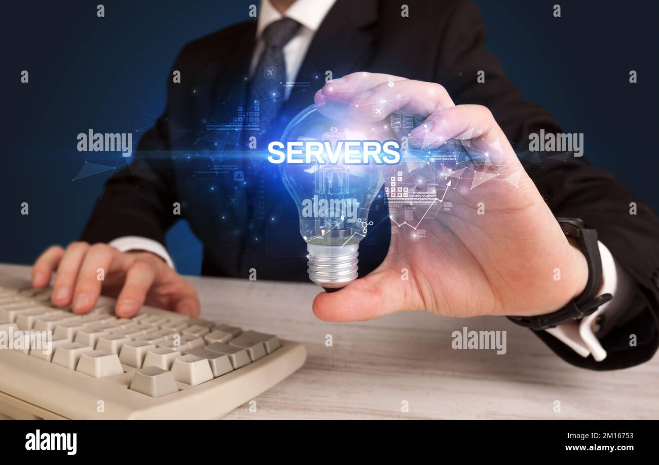 Businessman holding a light bulb Stock Photo - Alamy