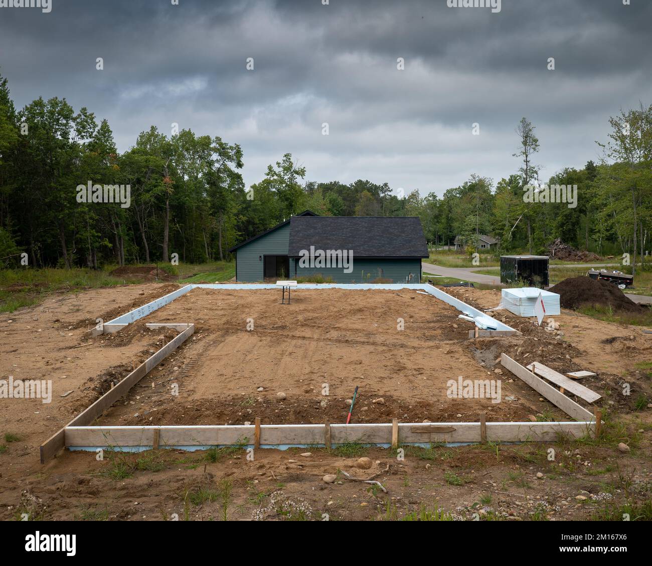 New house construction job site in a home development, with wood forms ...