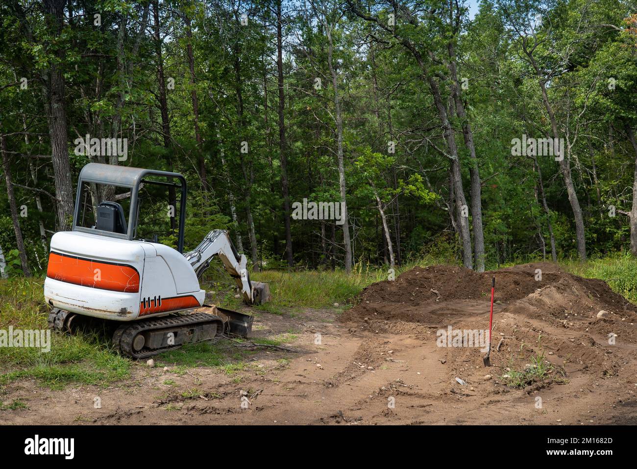 Mini excavator machine at a new home construction site with exposed ...