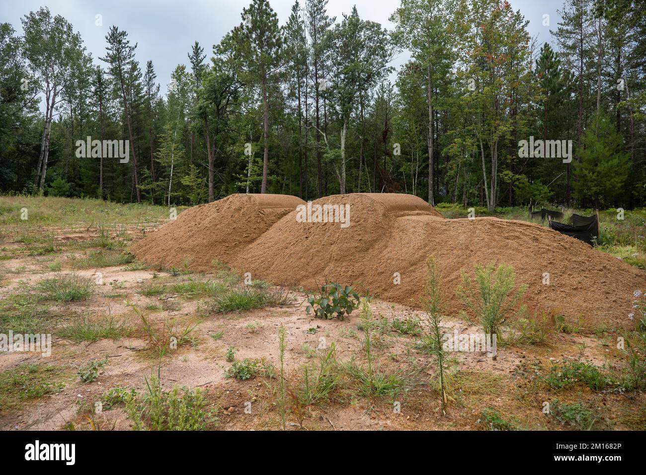 Piles of dirt that were hauled and dumped on an empty lot at a new home ...