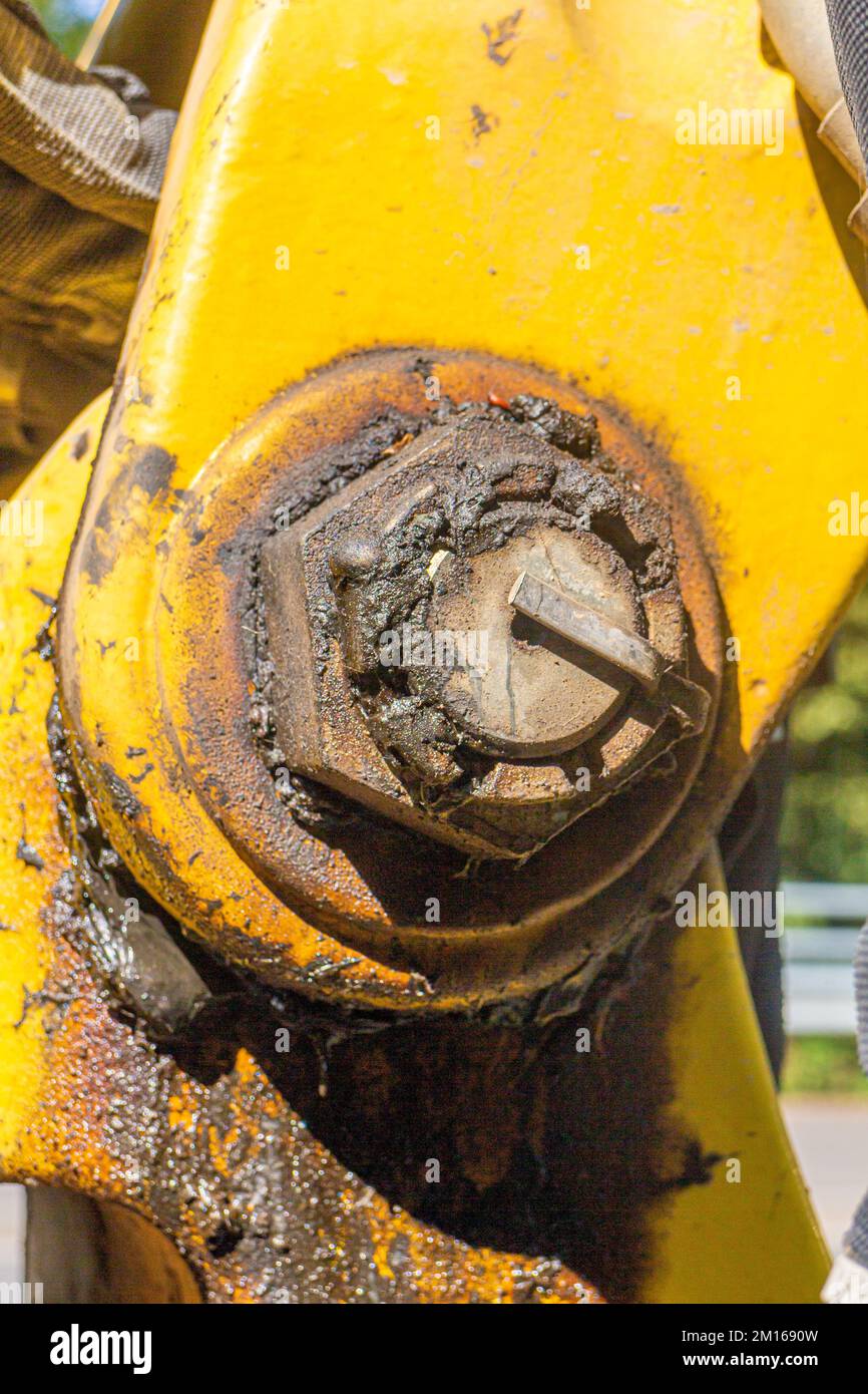 close up of a yellow joint on the arm of a shovel excavator with a lot ...
