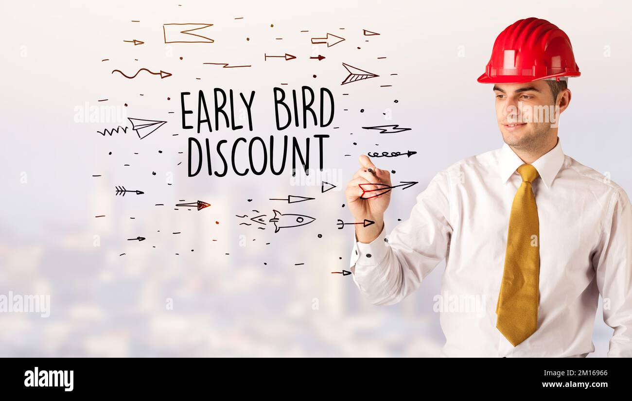 Young businessman with helmet drawing sale sign Stock Photo - Alamy