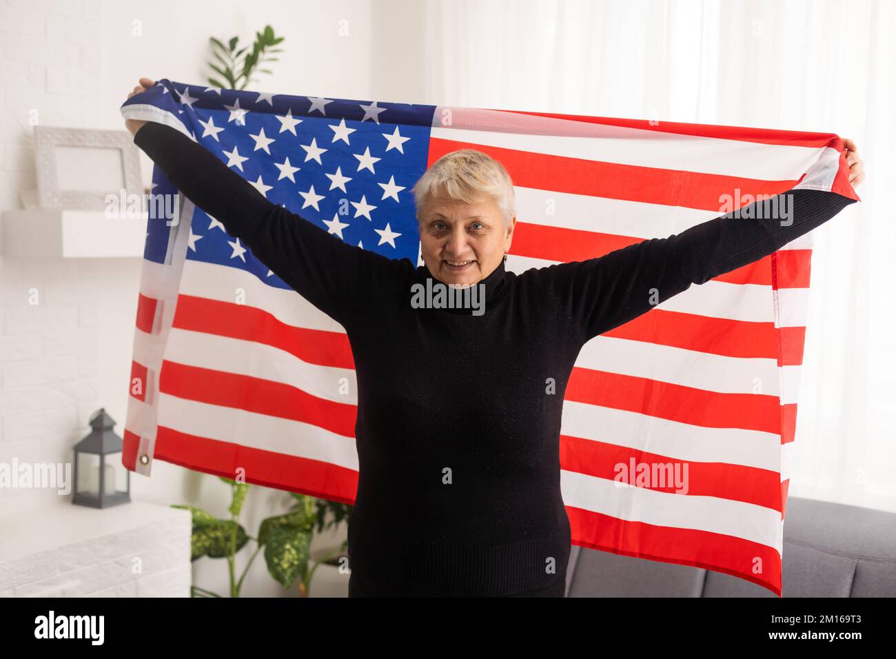 Elderly woman holding an American flag Stock Photo - Alamy