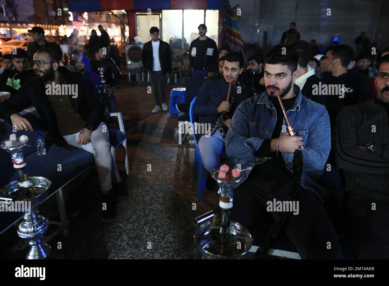 Baghdad, Iraq. 10th Dec, 2022. Iraqis watch the FIFA World Cup Qatar ...