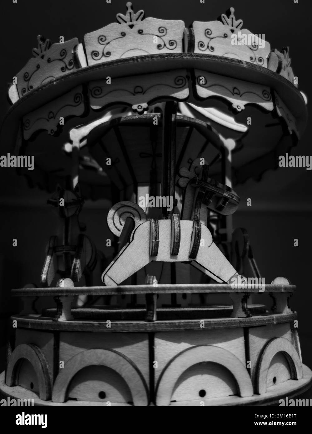 A vertical black and white shot of a steampunk wooden carousel in ...