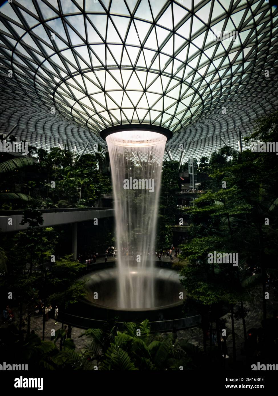 A vertical shot of the modern water fountain in Jewel Changi Airport in ...