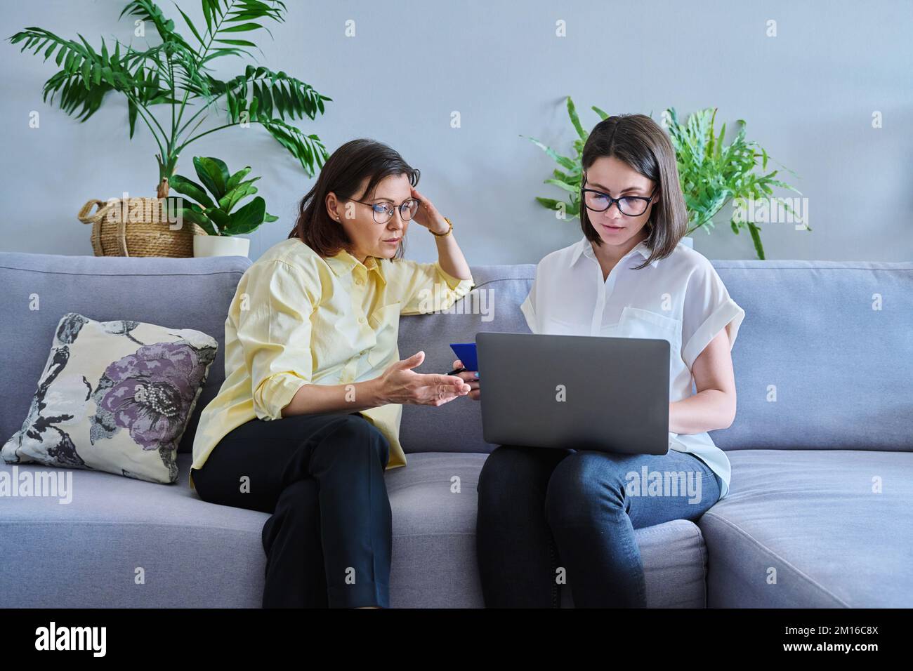 Female psychologist and middle aged woman patient sitting together on ...