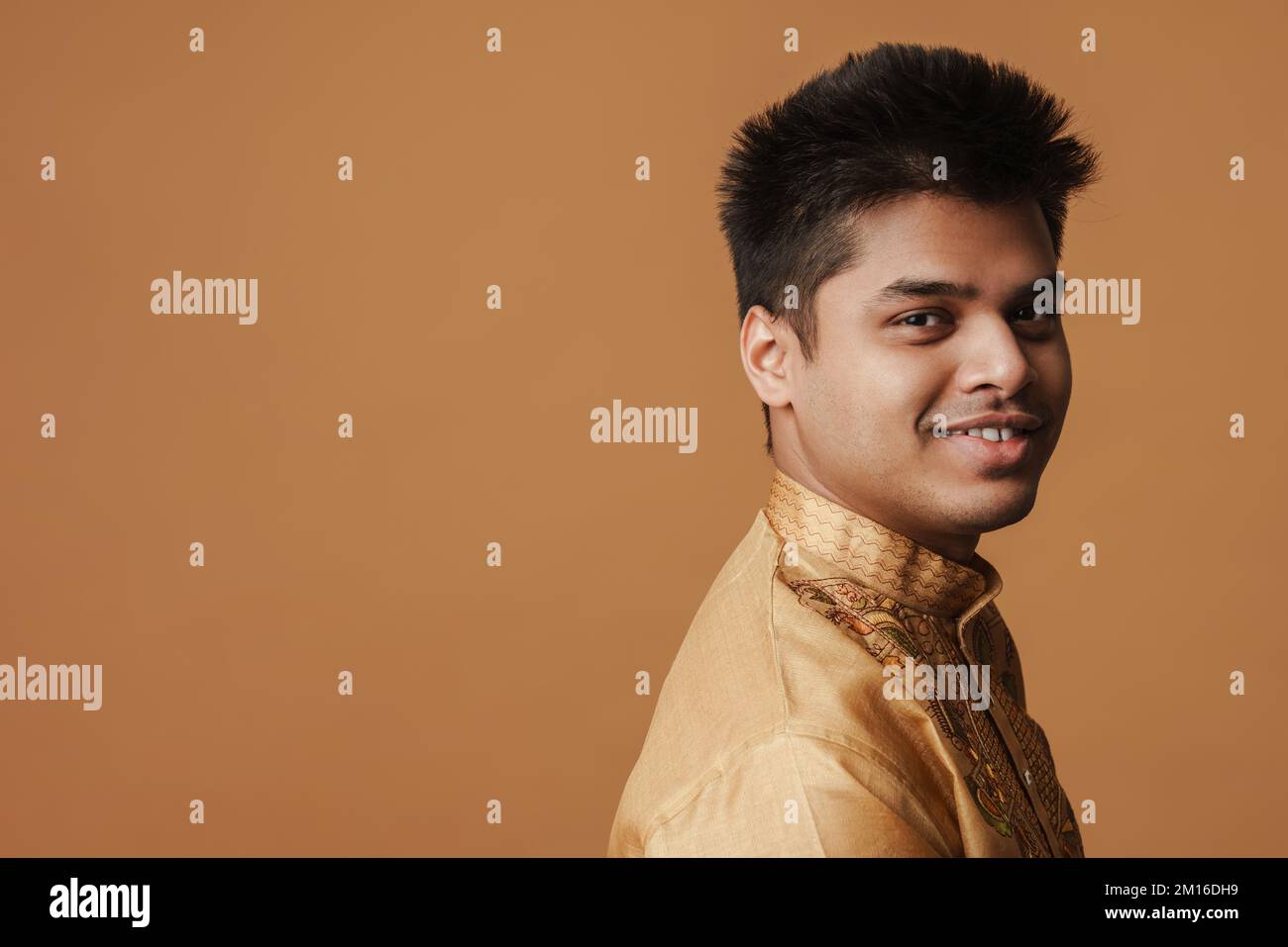Young brunette indian man smiling and looking at camera isolated over ...