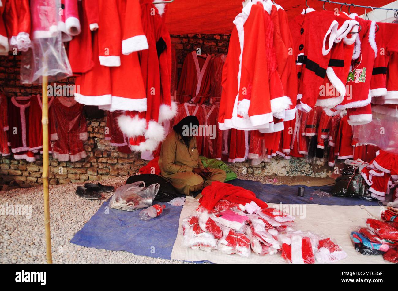 ISLAMABAD, PAKISTAN.A vendor is displaying and selling Santa Claus ...