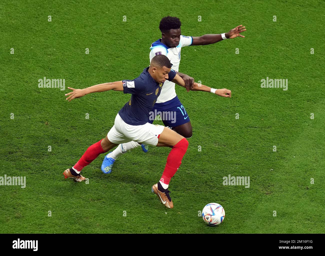 France's Kylian Mbappe (left) and England's Bukayo Saka battle for the ...