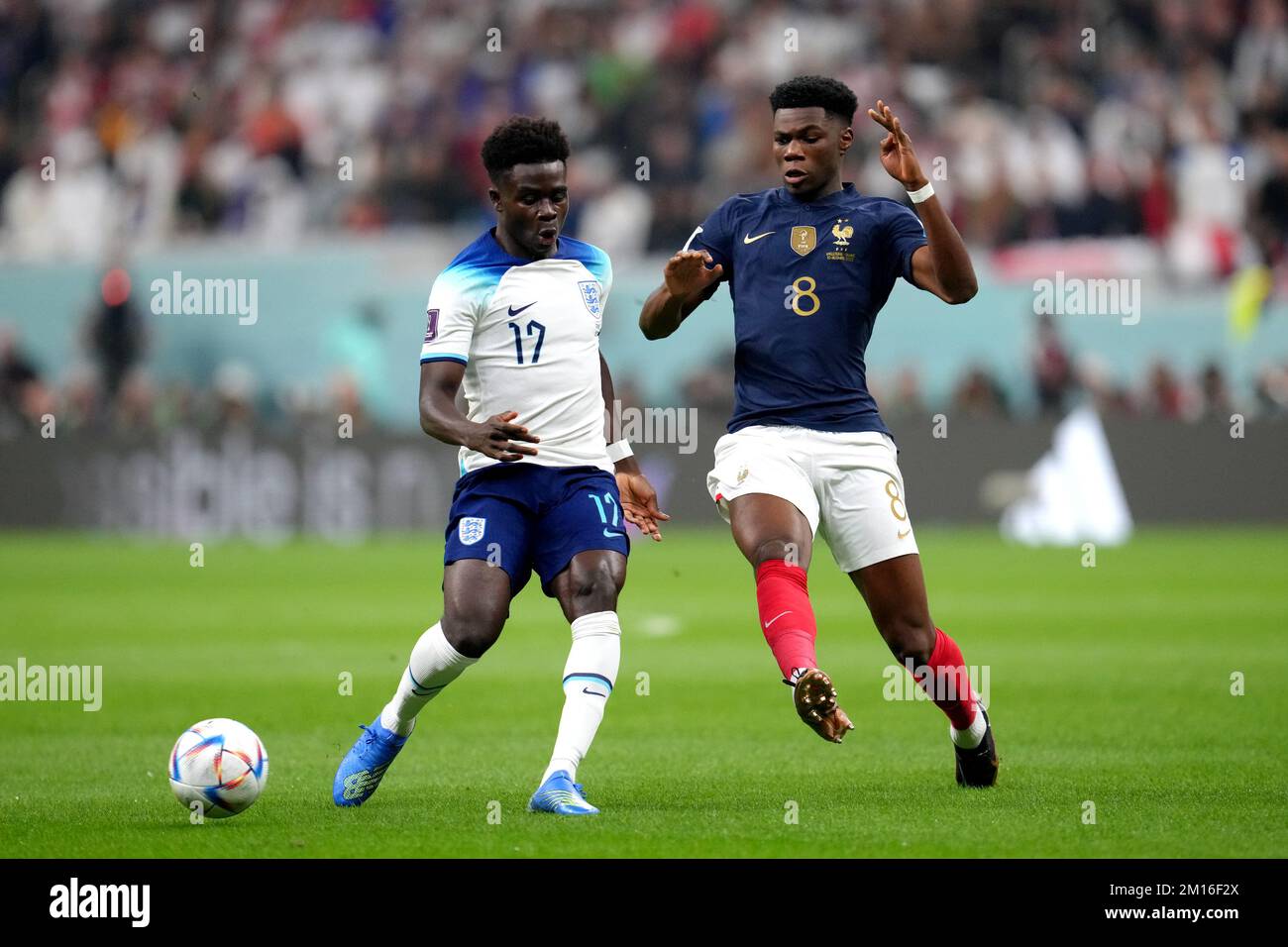 England's Bukayo Saka, (left) battles for possession of the ball with ...