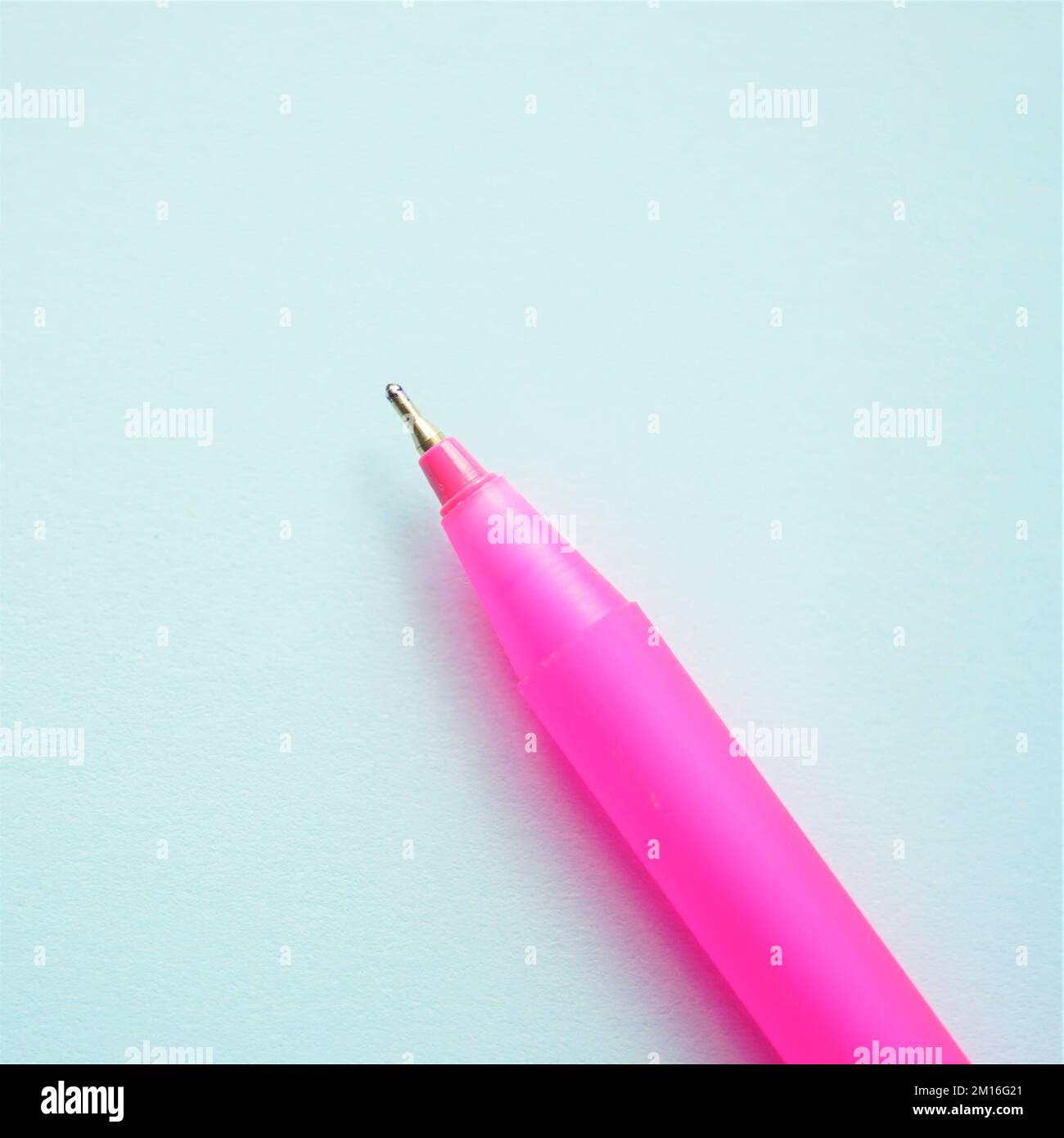 Pink ballpoint pen on pale blue paper Stock Photo - Alamy