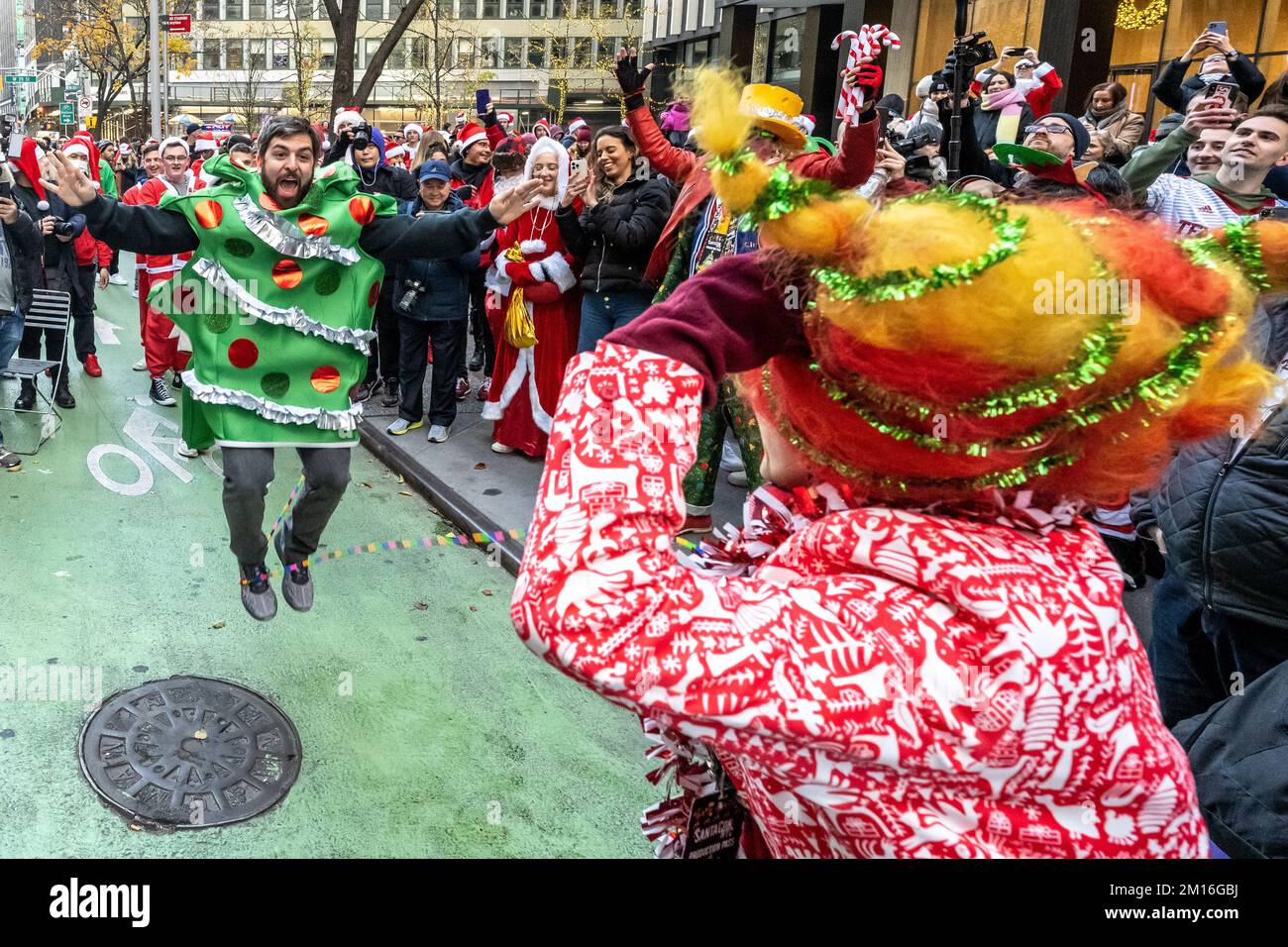 New York, USA. 10th Dec, 2022. Revelers dressed as Santa Claus have fun ...