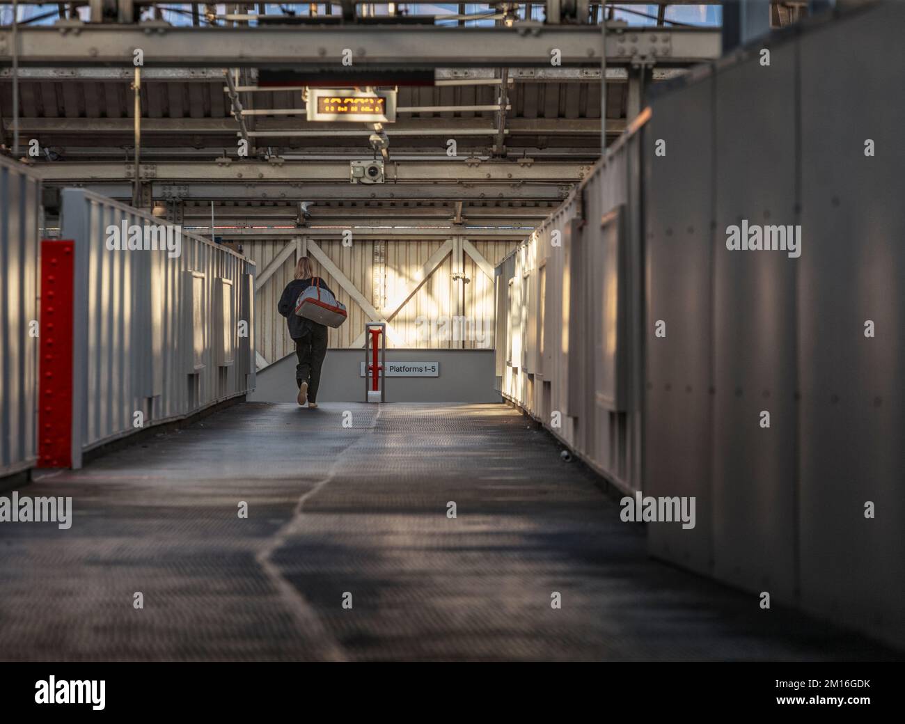Lone Railway passenger crossing the footbridge at Crewe railway station ...