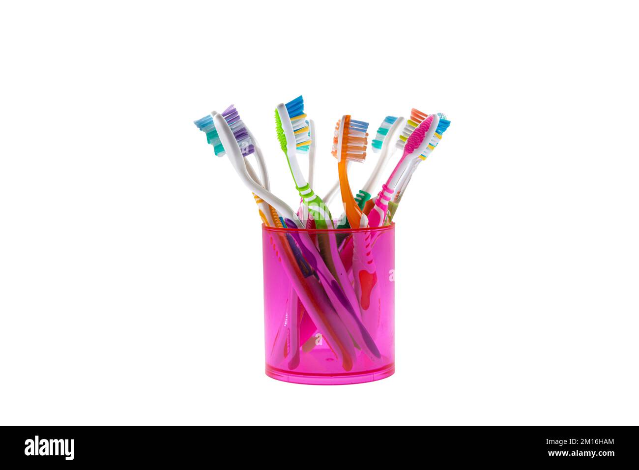 Toothbrush, toothbrush close-up. Set of toothbrushes in pink glass bowl ...