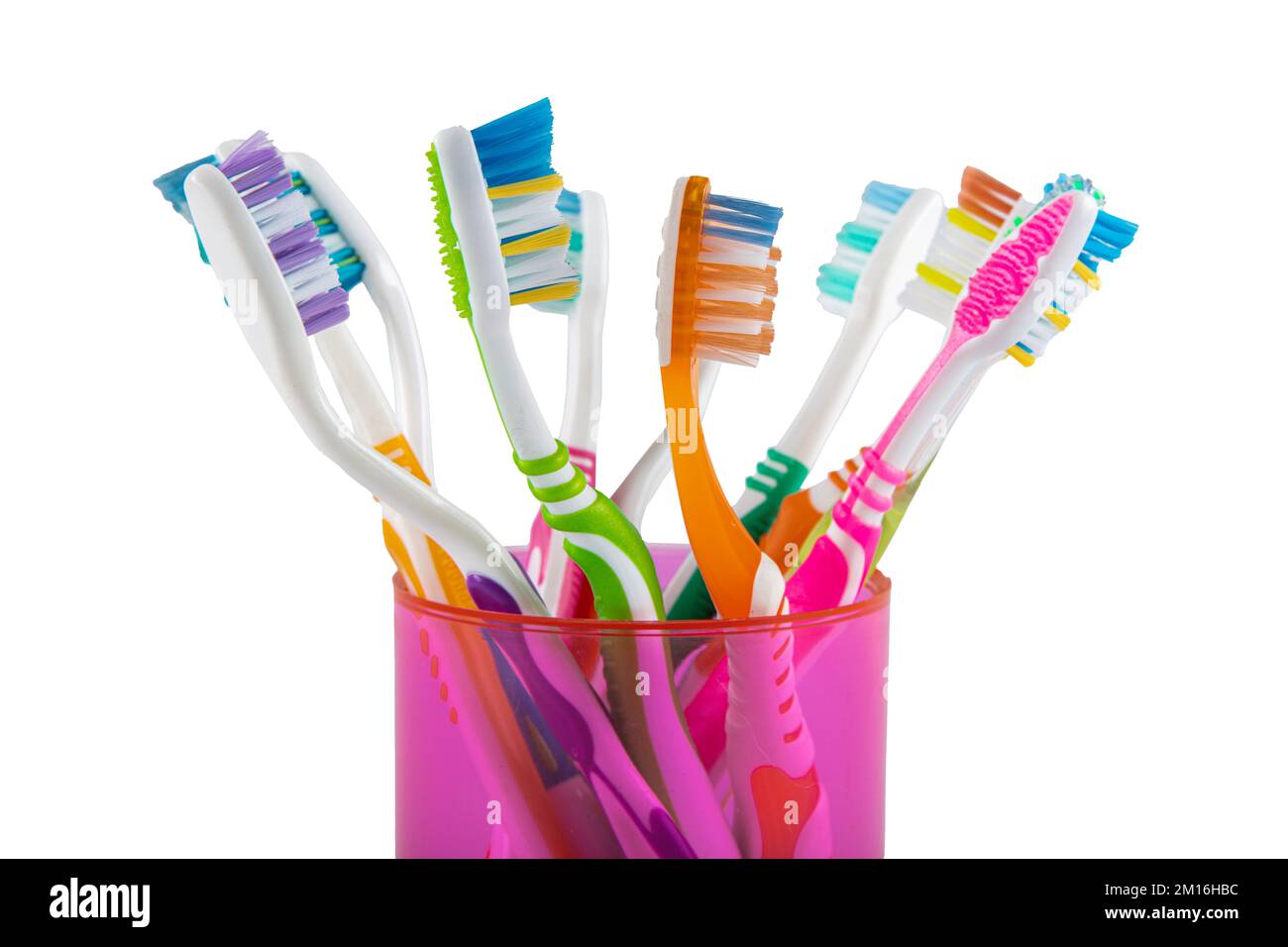 Toothbrush, toothbrush close-up. Set of toothbrushes in pink glass bowl ...