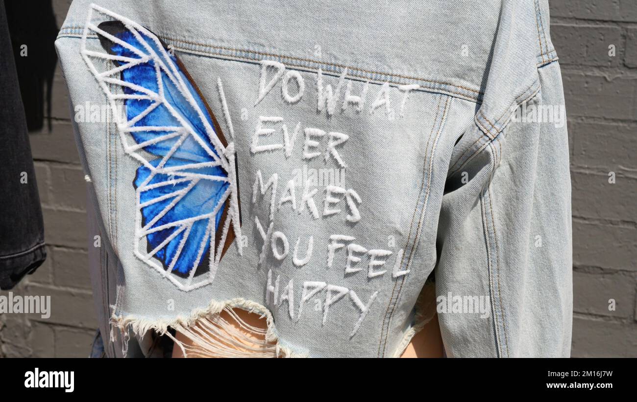 "Do Whatever Makes You Happy" written on the back of a denim jeans ...