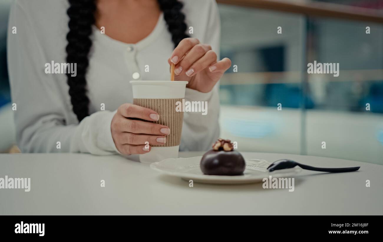 Unknown woman customer shopper girl student sit at cafe restaurant stir ...