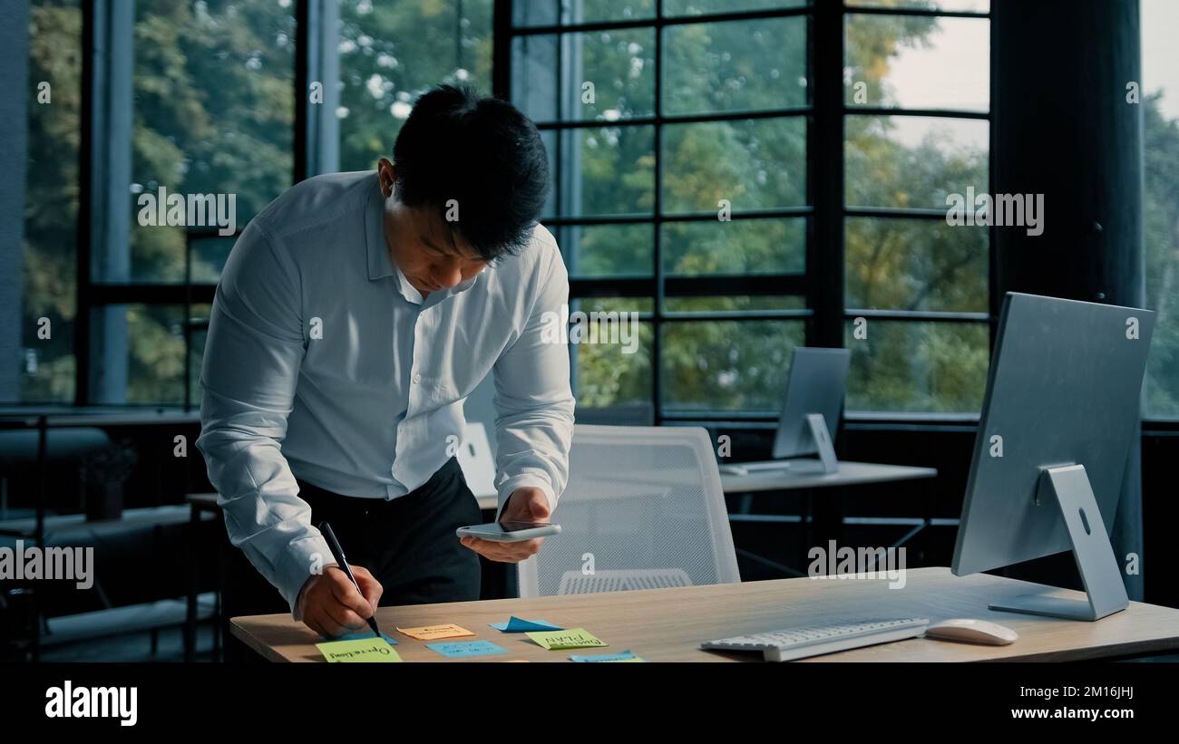 Senior asian ethnic man entrepreneur businessman stand at table in ...