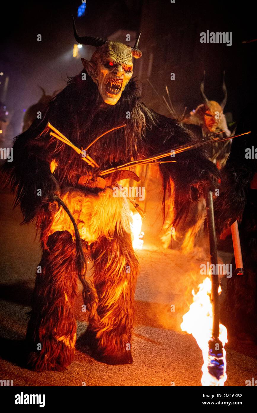 Masked devil beasts parade through the village scaring the crowd while ...