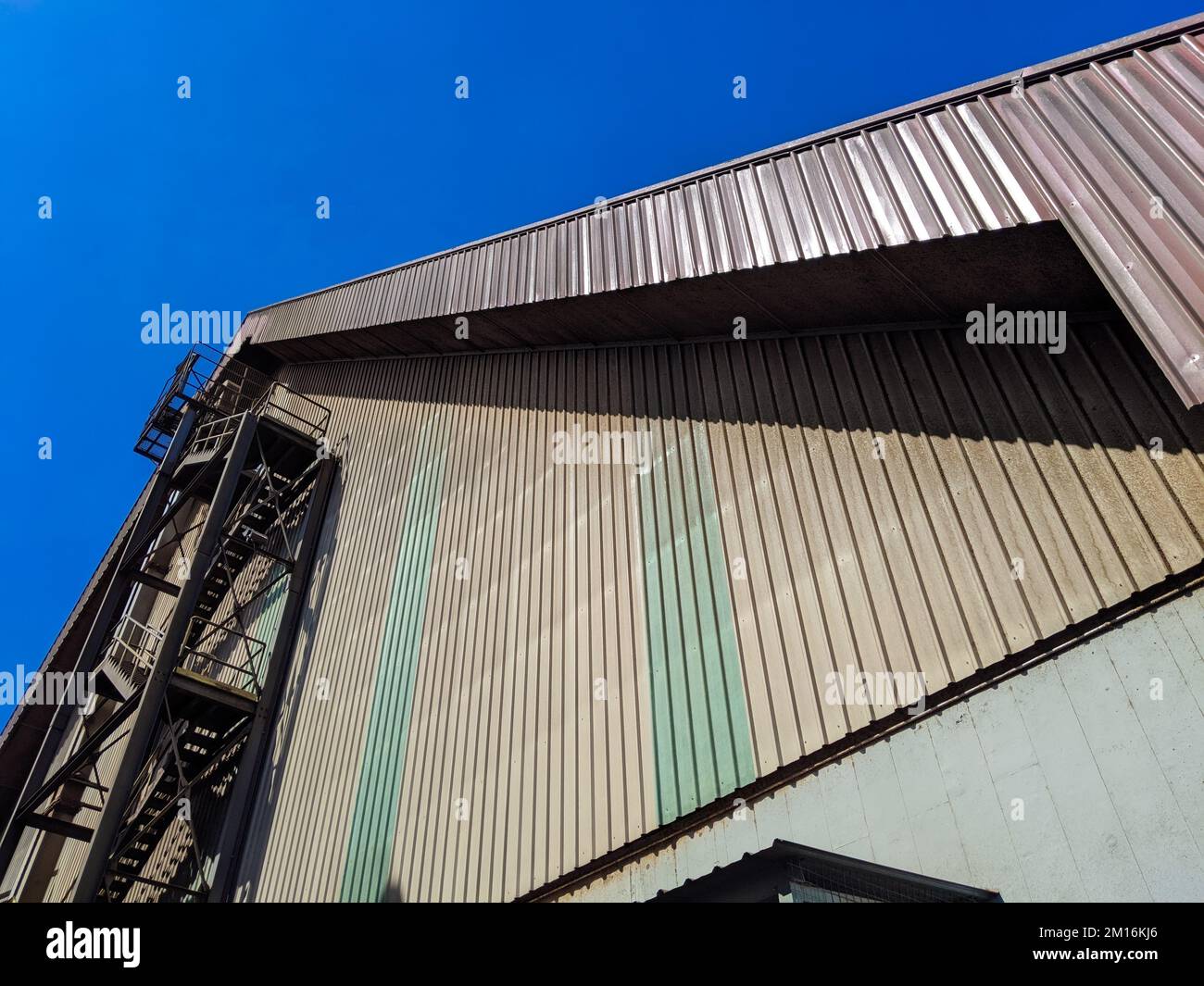 A low angle shot of a kernel processing plant and kernel dust warehouse ...