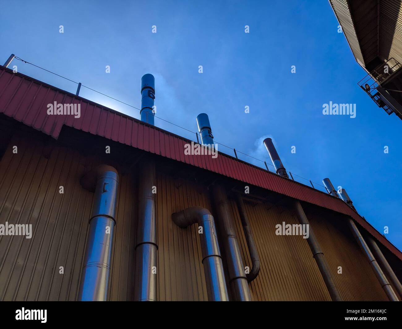 A low angle shot of a kernel processing plant and kernel dust warehouse ...