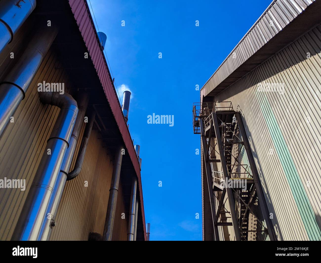 A low angle shot of a kernel processing plant and kernel dust warehouse ...