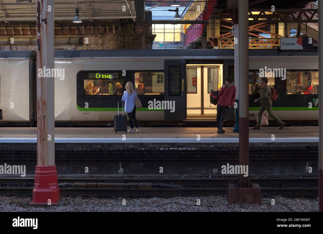Rail passengers waiting in front of a London North Western Railway ...