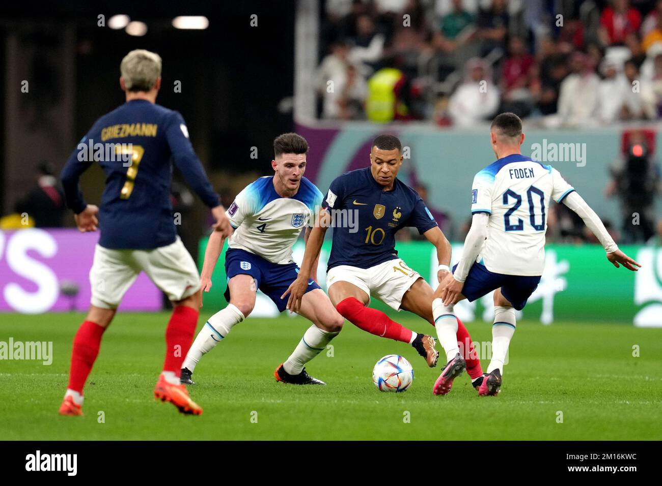 France's Kylian Mbappe is watched by England's Declan Rice, (left) and ...