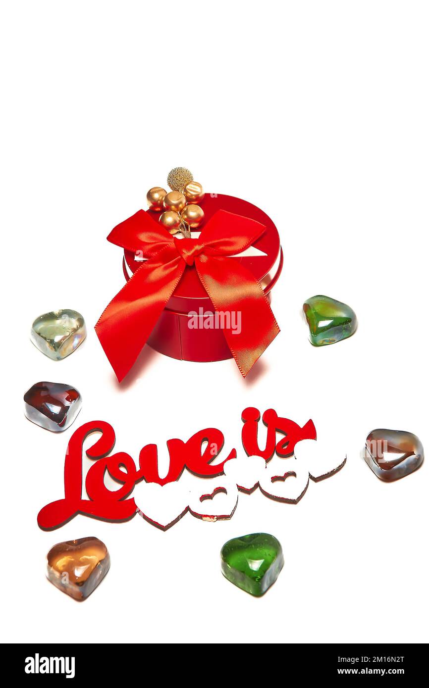 A Red Round Box With A Bow And The Inscription Love Is Surrounded By