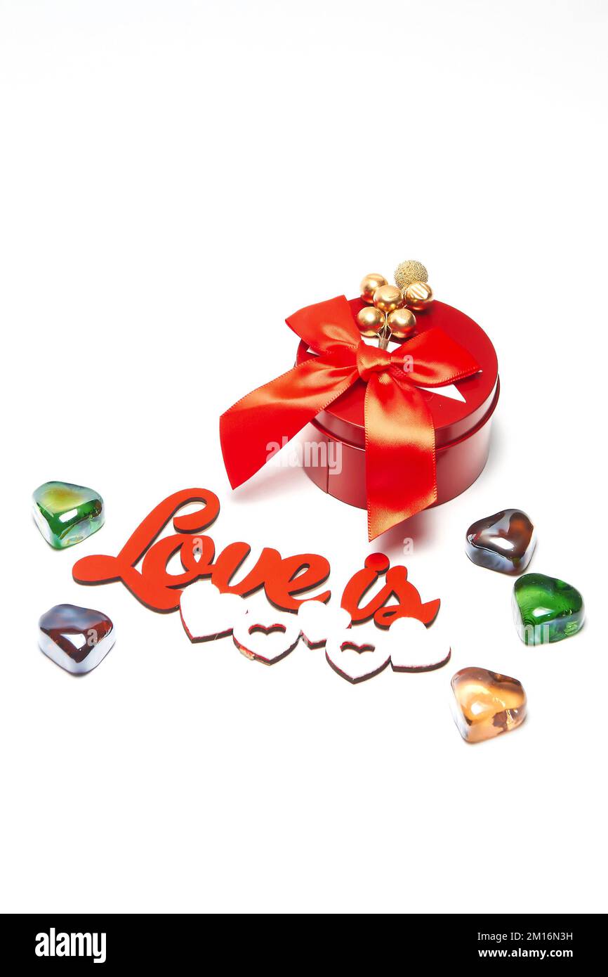 A Red Round Box With A Bow And The Inscription Love Is Surrounded By