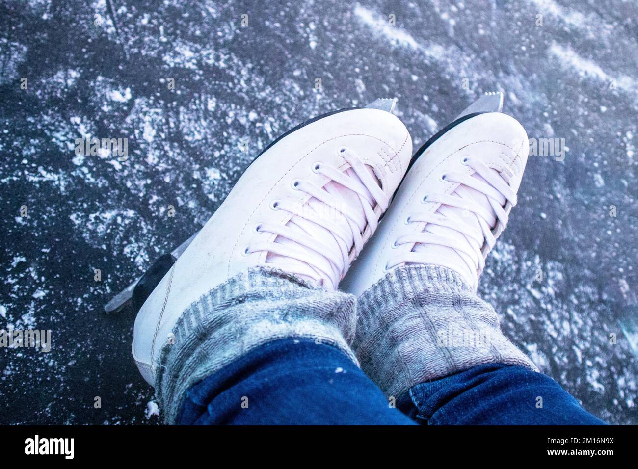 white figure skates close-up on the background of ice Stock Photo - Alamy