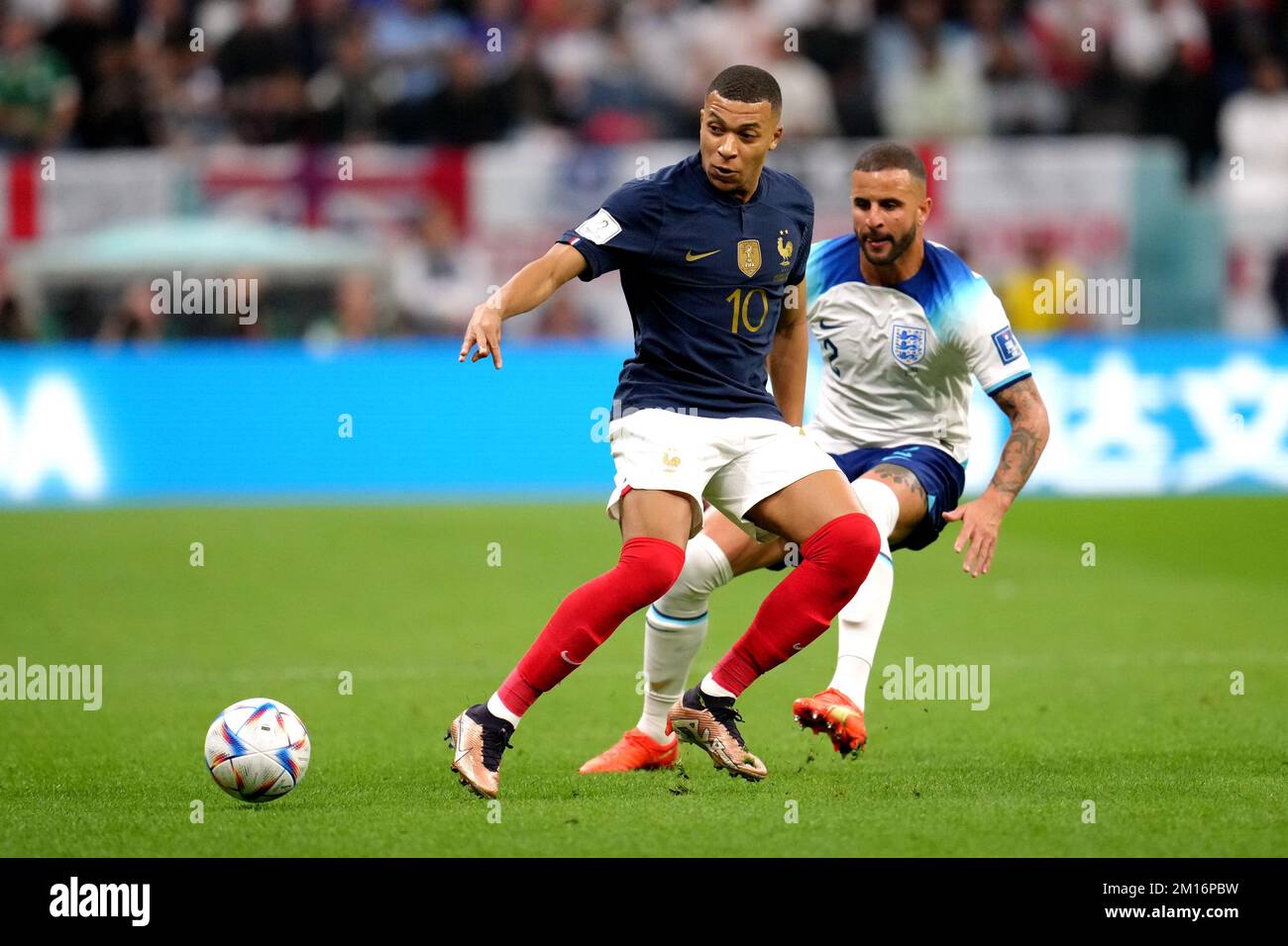 France's Kylian Mbappe is watched over by England's Kyle Walker, (right ...