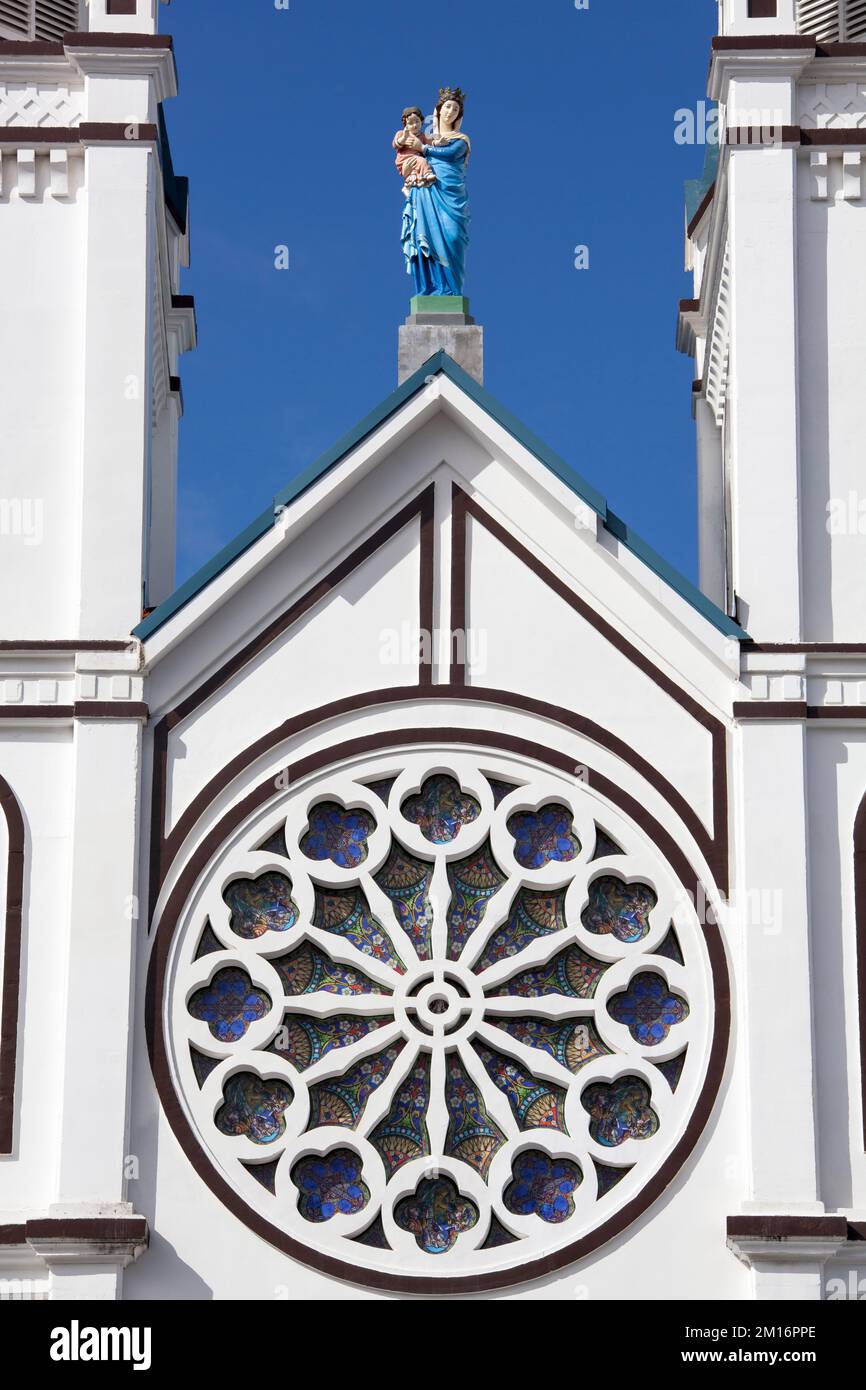 The colorful circular exterior with a statue on a top of Immaculate ...